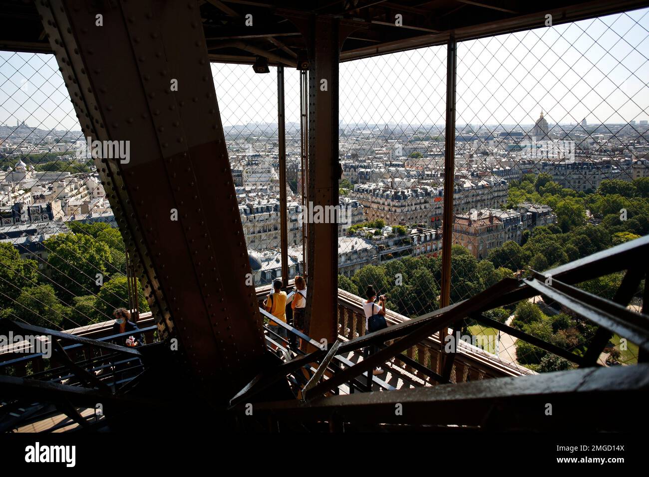 Visitors look at the view from the Eiffel Tower, in Paris, Thursday ...