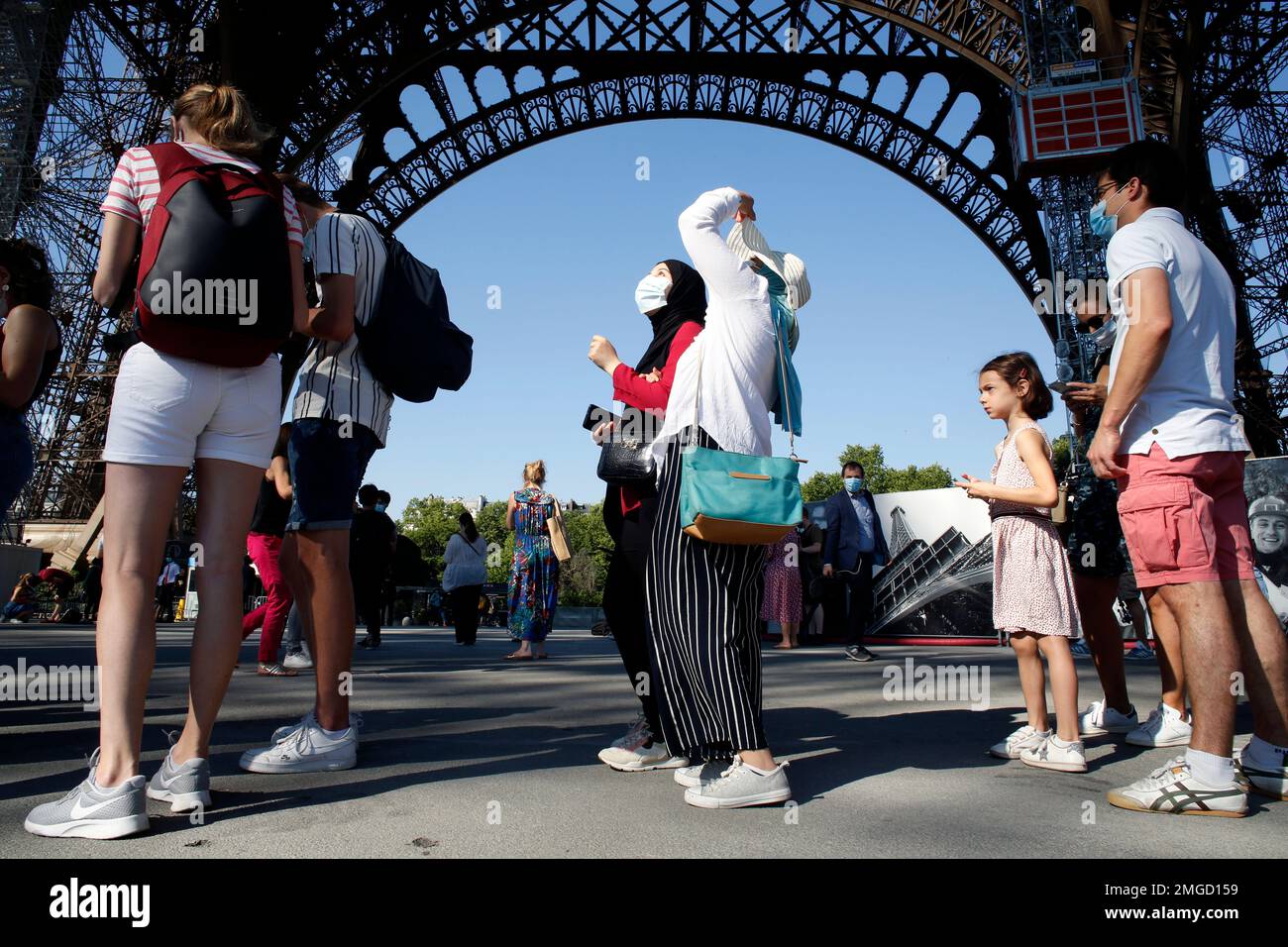 People queue up prior to visit the Eiffel Tower, in Paris, Thursday ...