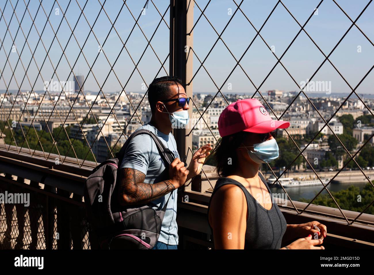 Visitors look at the view from the Eiffel Tower, in Paris, Thursday ...