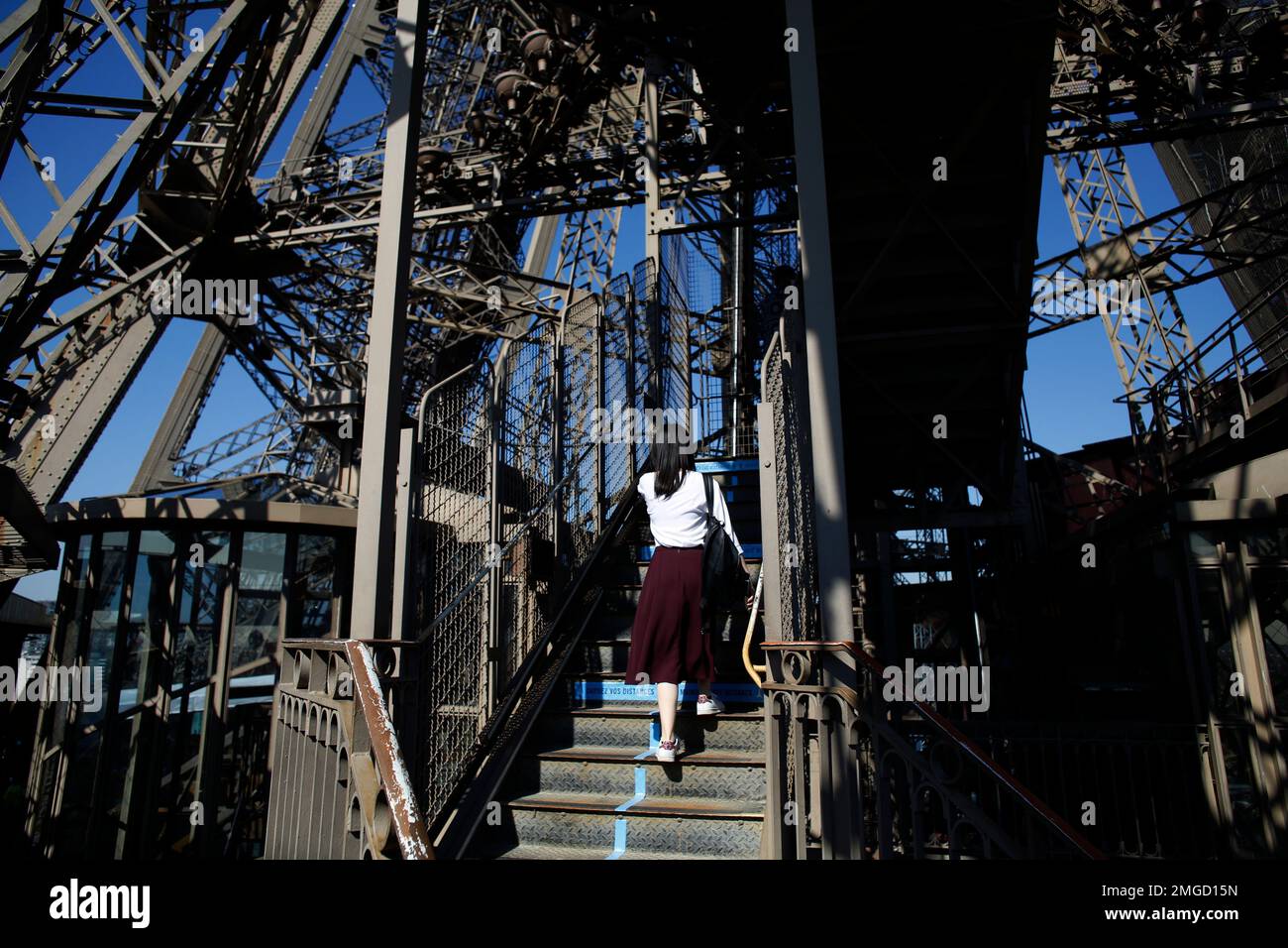 A visitor climbs the stairs of the Eiffel Tower, in Paris, Thursday ...