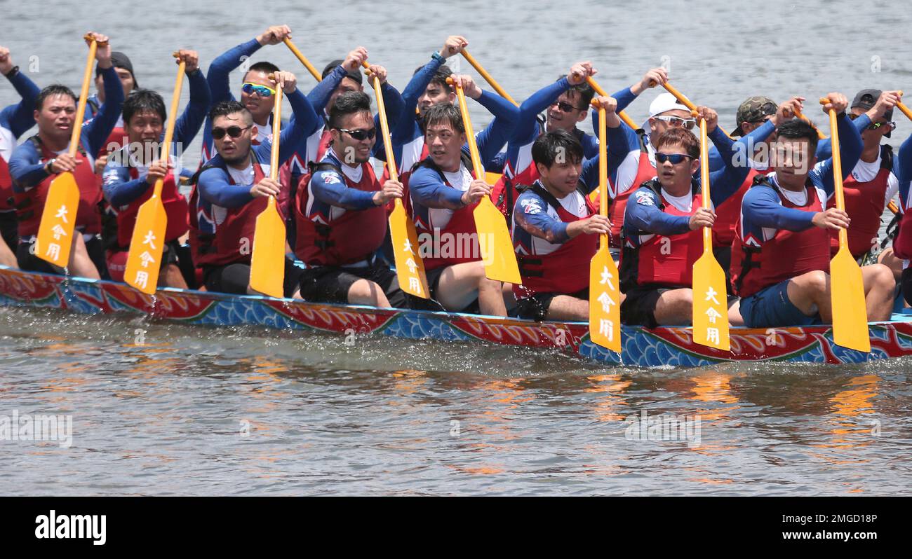 Dragon boat crew members participate in a traditional Chinese dragon ...