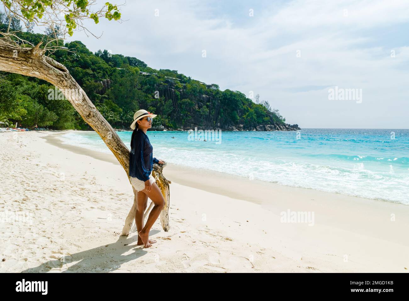 Young women at a tropical beach Petite Anse beach Mahe Seychelles ...