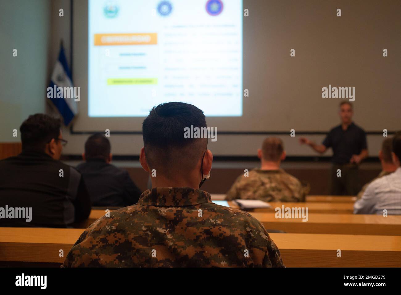 Airmen, Soldiers and civilians from El Salvador and the New Hampshire National Guard listen to a ...