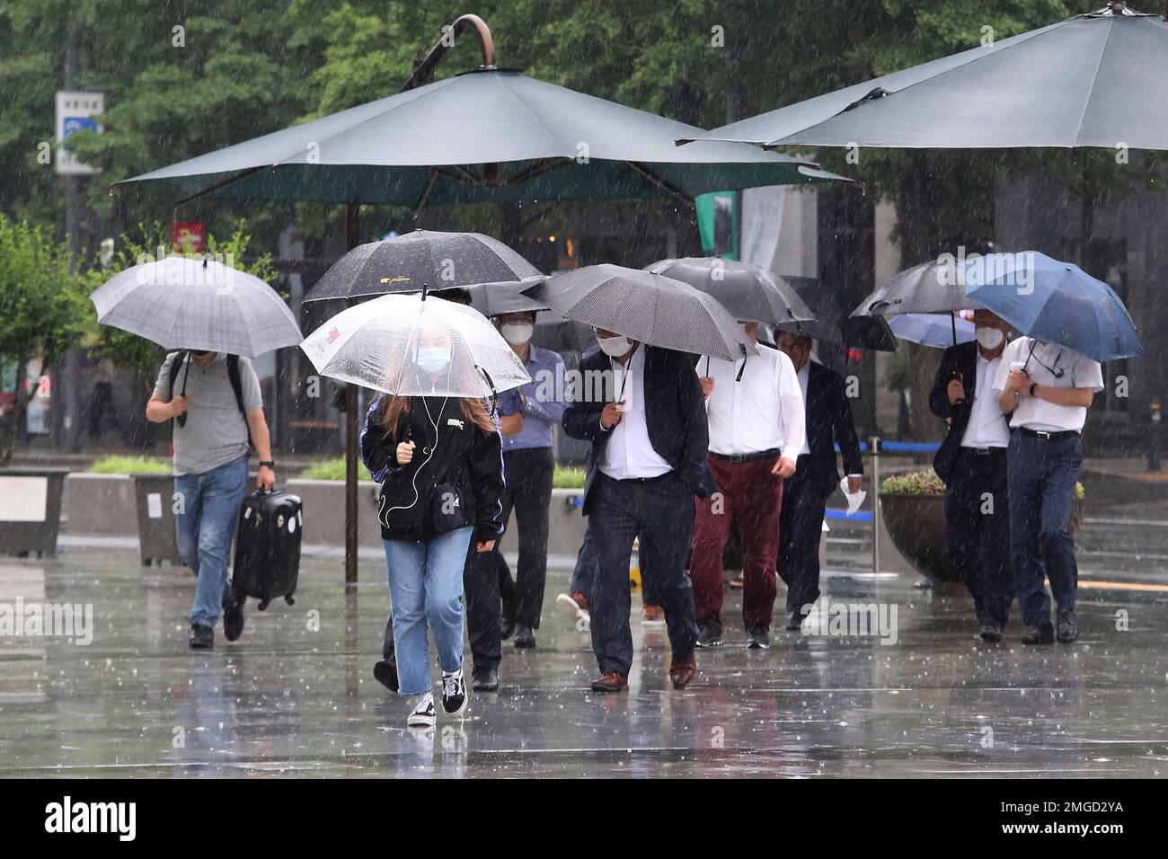 People wearing face masks to help protect against the spread of the new ...