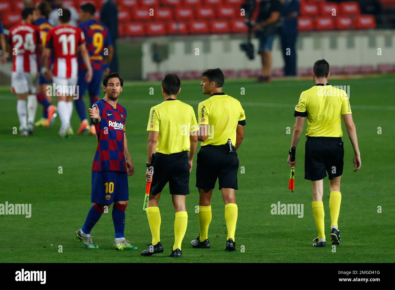 Barcelona's Lionel Messi, left, talks with the referee Jesus Gil ...