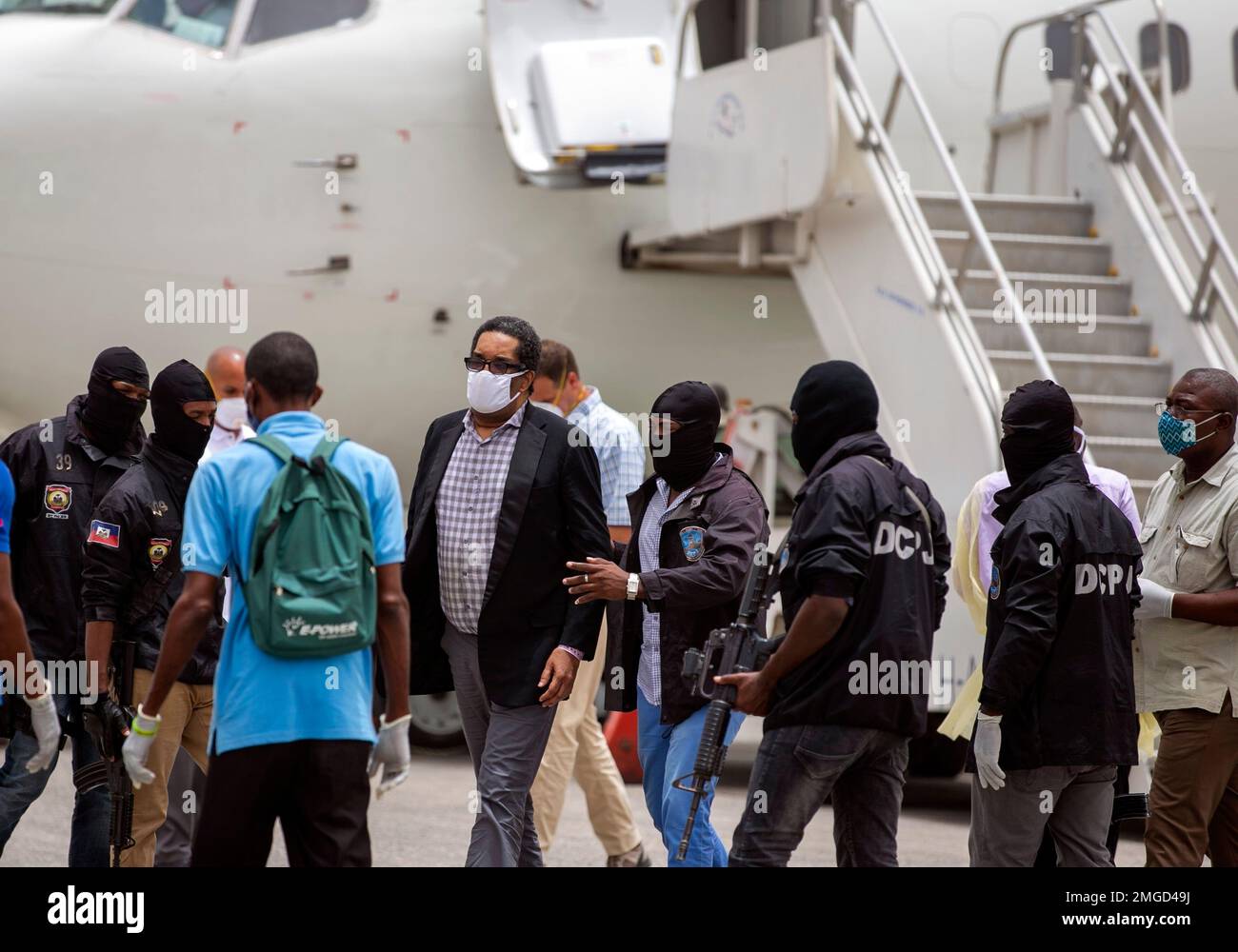 Former paramilitary leader Emmanuel Constant, center, is detained by ...