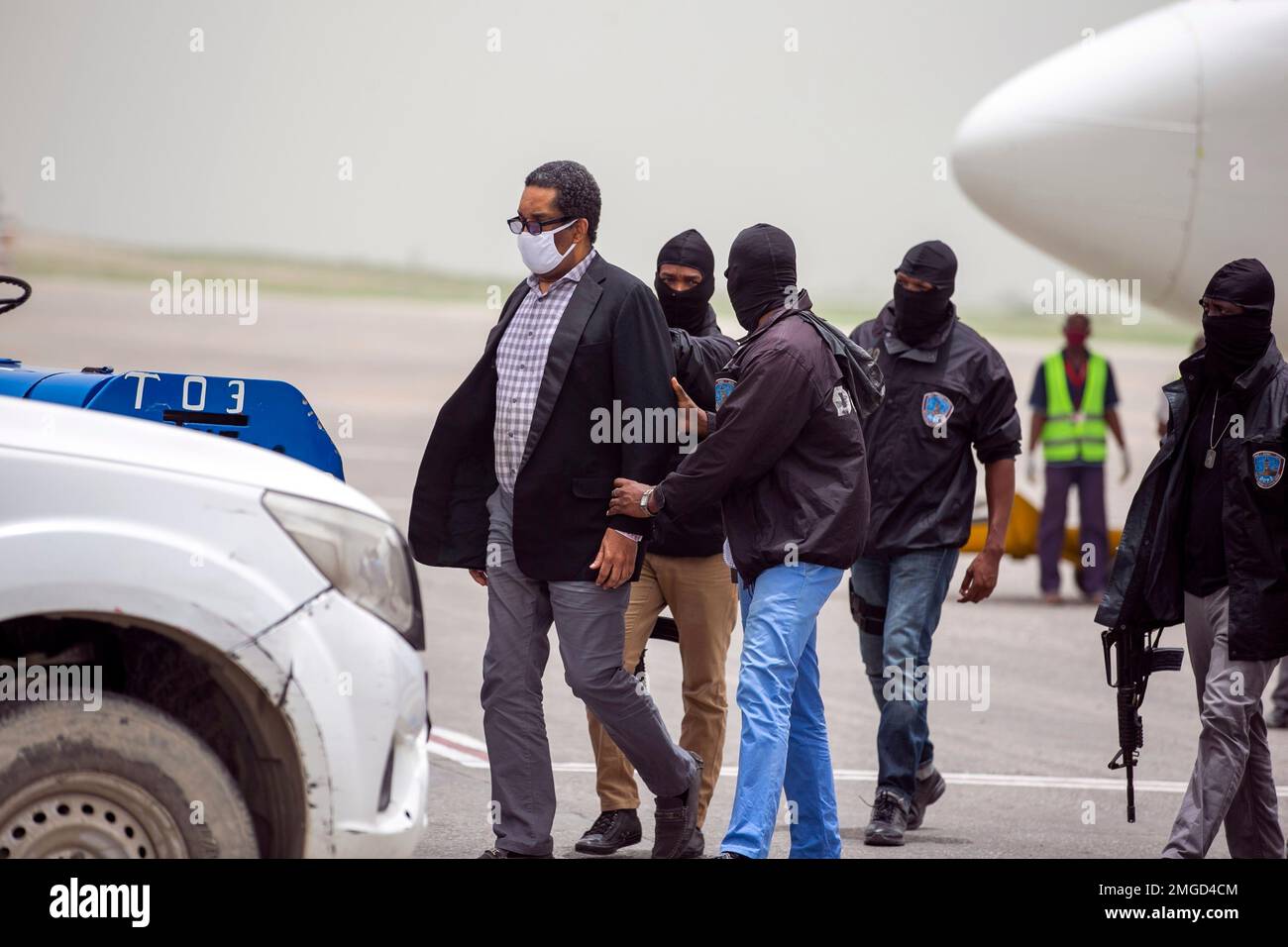 Former paramilitary leader Emmanuel Constant, center, is detained after ...