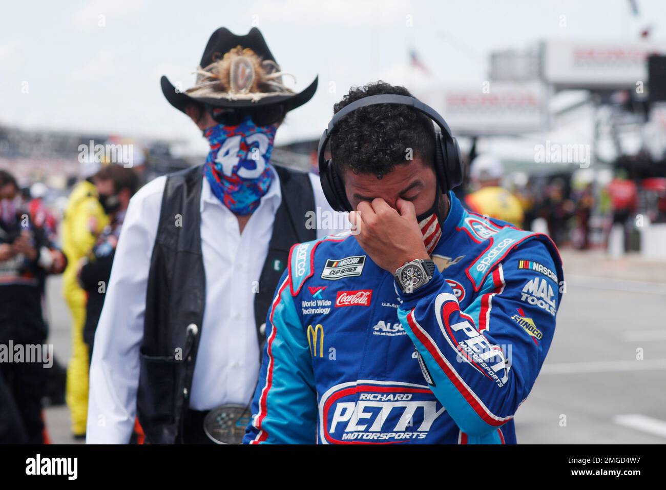 Team owner Richard Petty, left watches as driver Bubba Wallace wipes ...