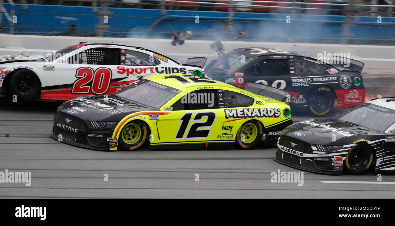Winner Ryan Blaney (12) approaches the finish line as driver Erik Jones ...