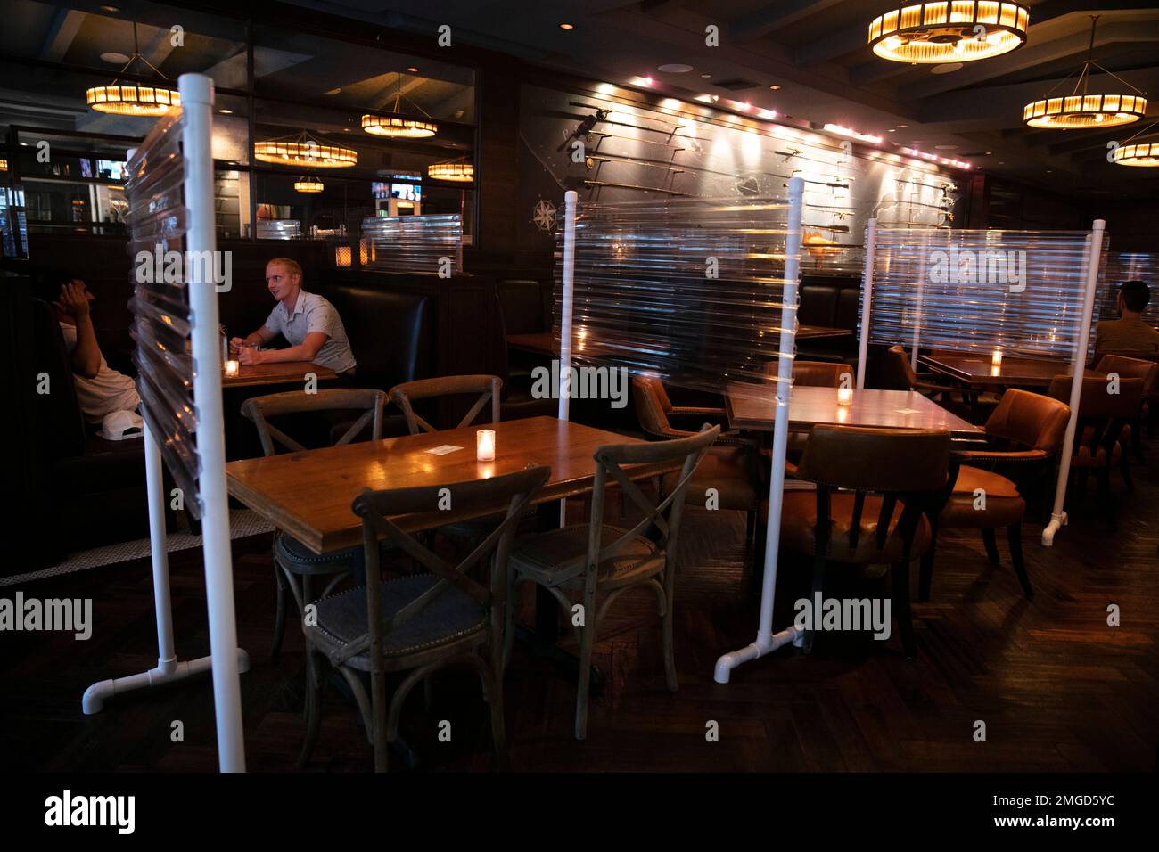 Protective dividers are installed between tables at Water Grill seafood ...