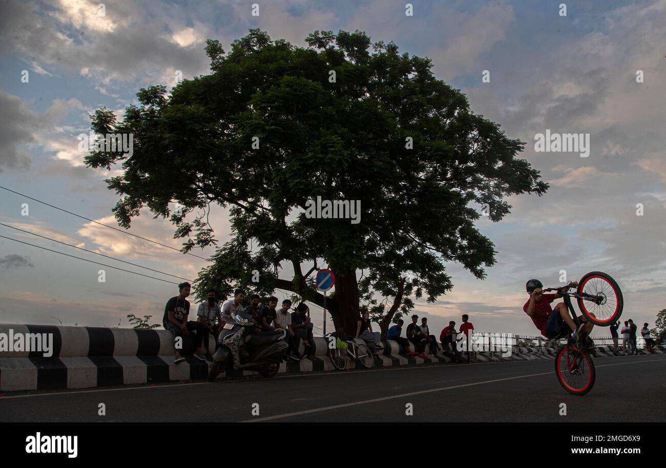 Indian student Deepjyoti Lahon, 20, practices stunts on his bicycle on ...