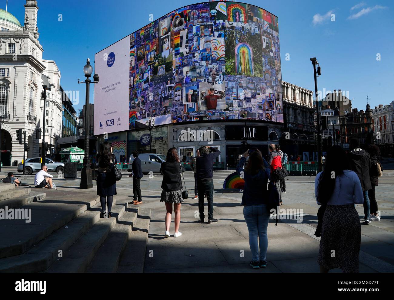People watch as pictures appear on a screen during a 10 minute ...
