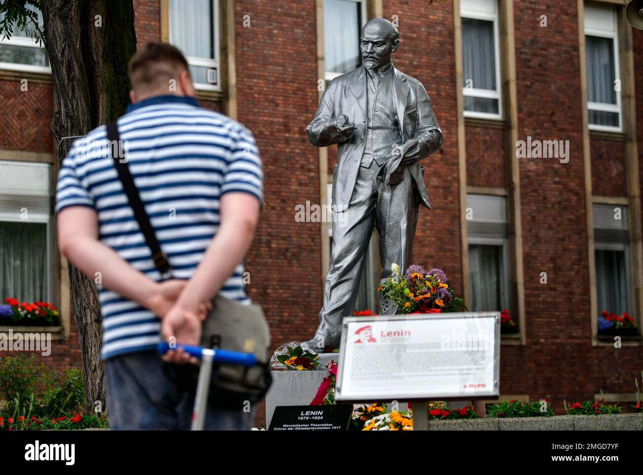 A man watches the controversial Lenin statue in Gelsenkirchen, Germany ...