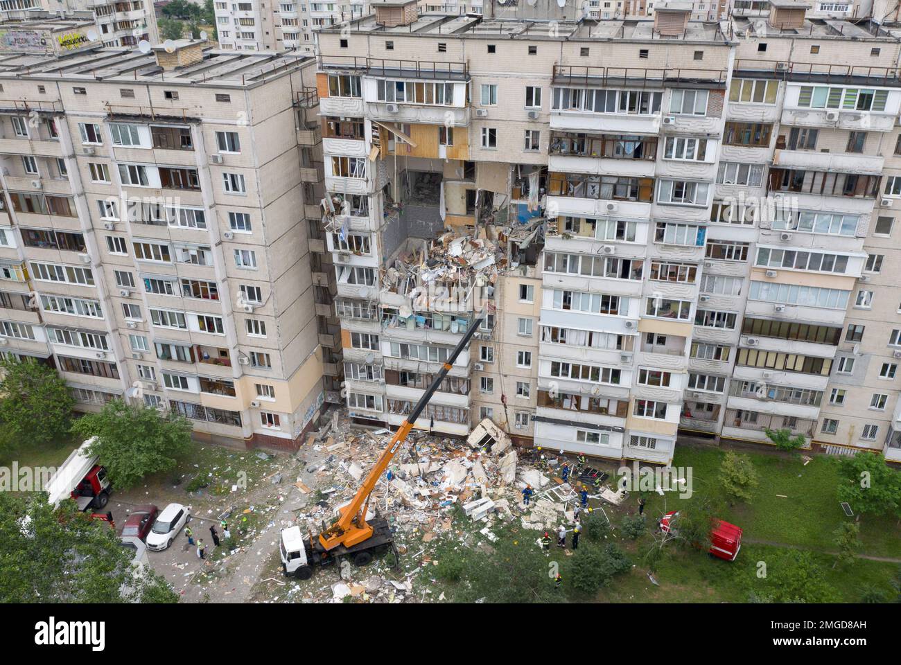 Rescuers work on a site of a deadly gas explosion in a multistory ...
