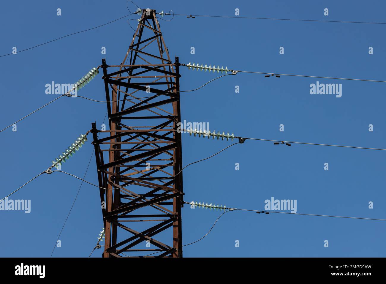 Power lines on background of blue sky close-up. Electric hub on pole ...