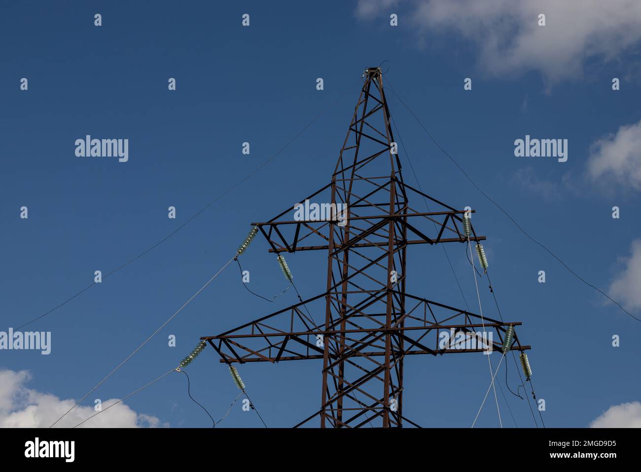 Power lines on background of blue sky close-up. Electric hub on pole ...