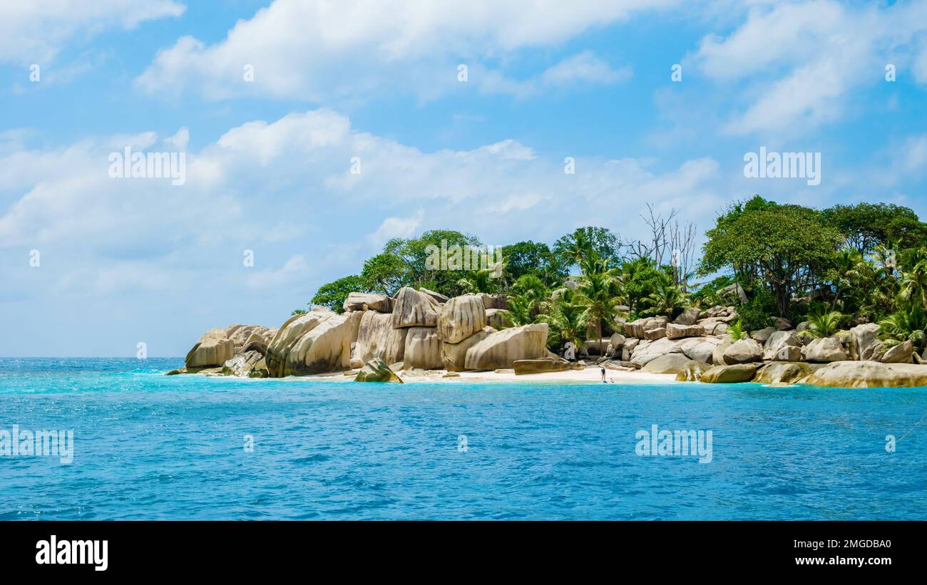 white tropical beach with huge boulders and palm trees Coco Island ...