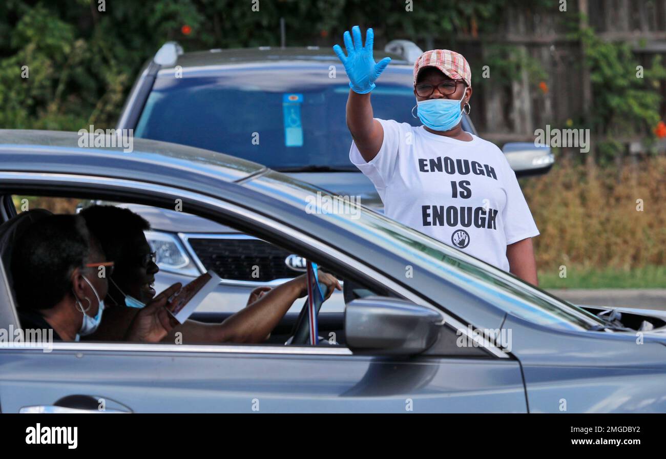 Tomika Jackson waves to people during a drive through Juneteenth 2020 ...