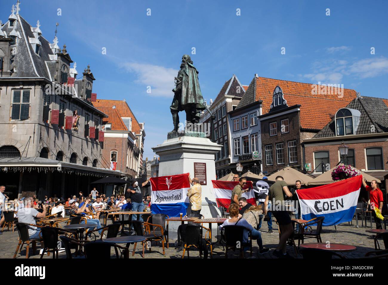 A few demonstrators in favor of keeping the statue hold Dutch flags at ...