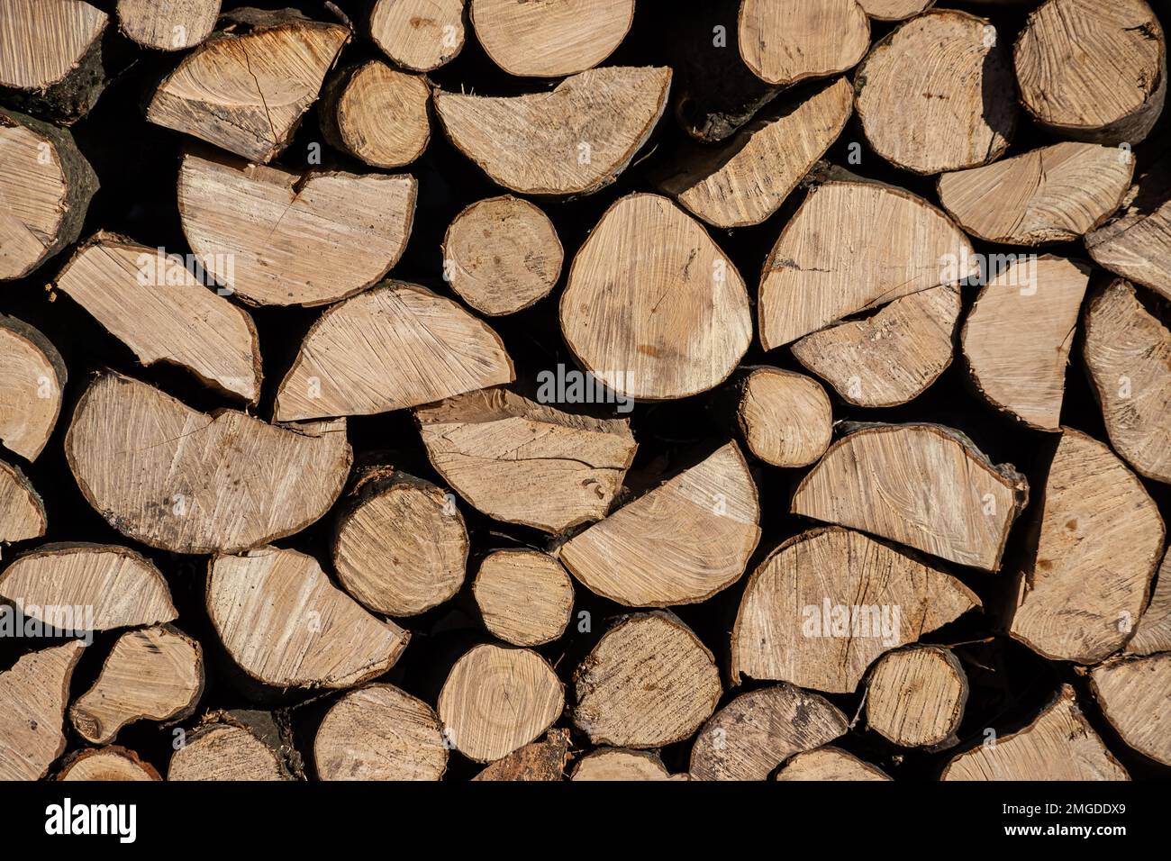 Pile of stacked triangle firewood prepared for fireplace and boiler ...