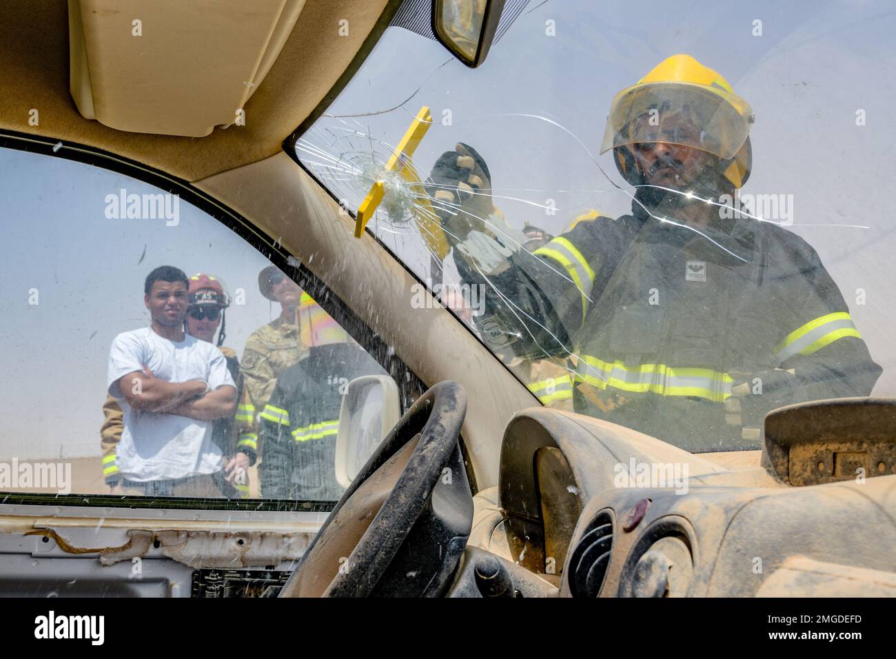A Royal Saudi Air Force firefighter uses a windshield saw to bust a ...