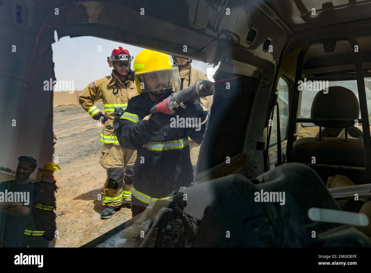 A Royal Saudi Air Force firefighter uses a reciprocating saw to cut ...