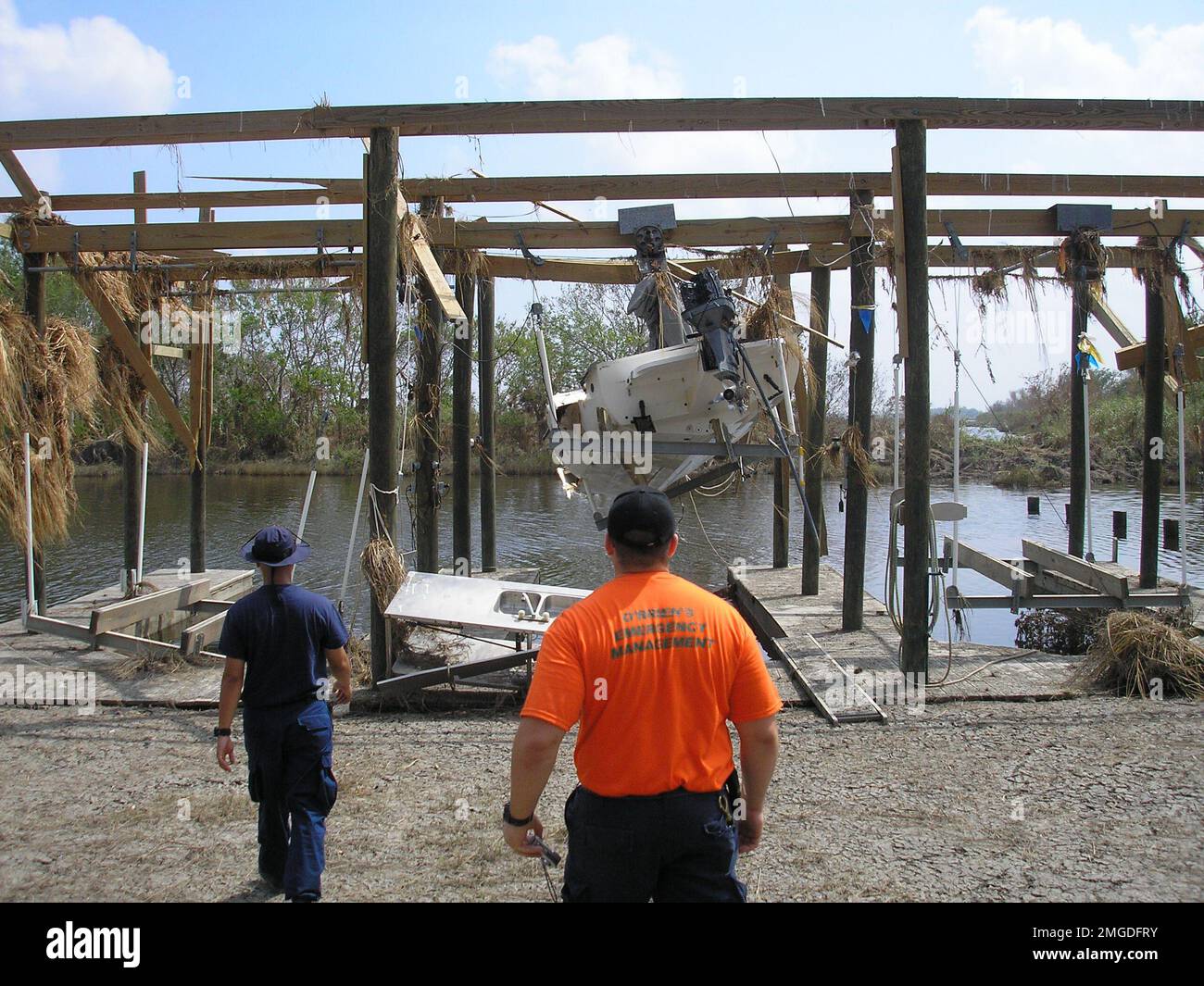 Aftermath - Miscellaneous - 26-HK-46-2. Coasties with boat hanging from ...