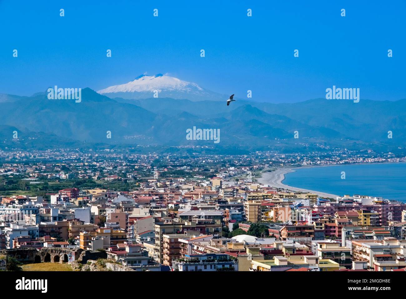 Aerial view of the city of Milazzo, located by the sea, and the volcano ...