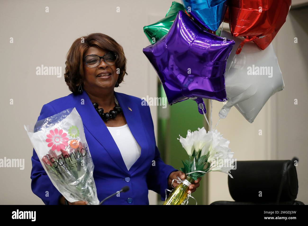Mayor Ella Jones, right, holds balloons and flowers after being sworn ...
