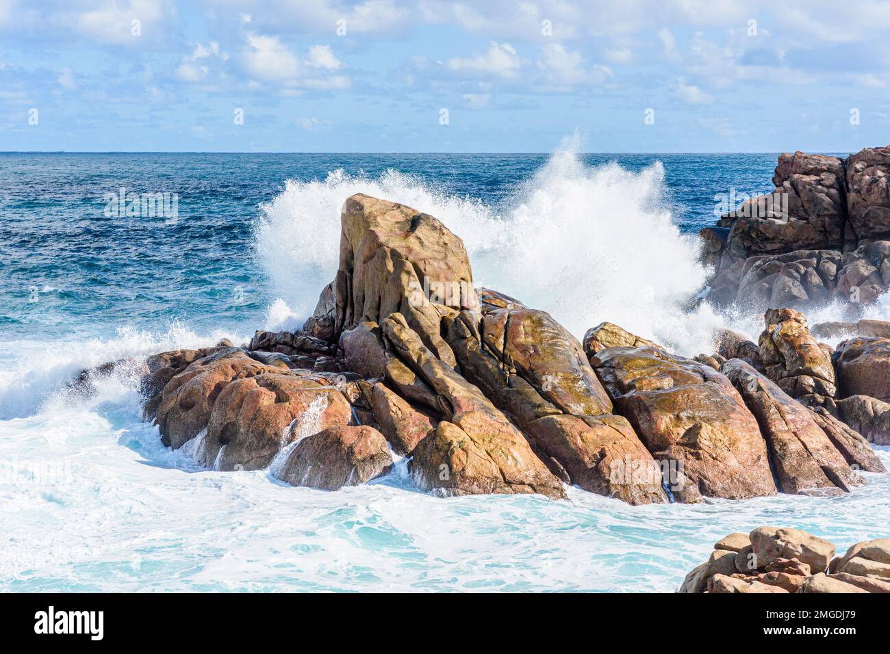 Waves crashing over granite gneiss metamorphic rocks along the ...