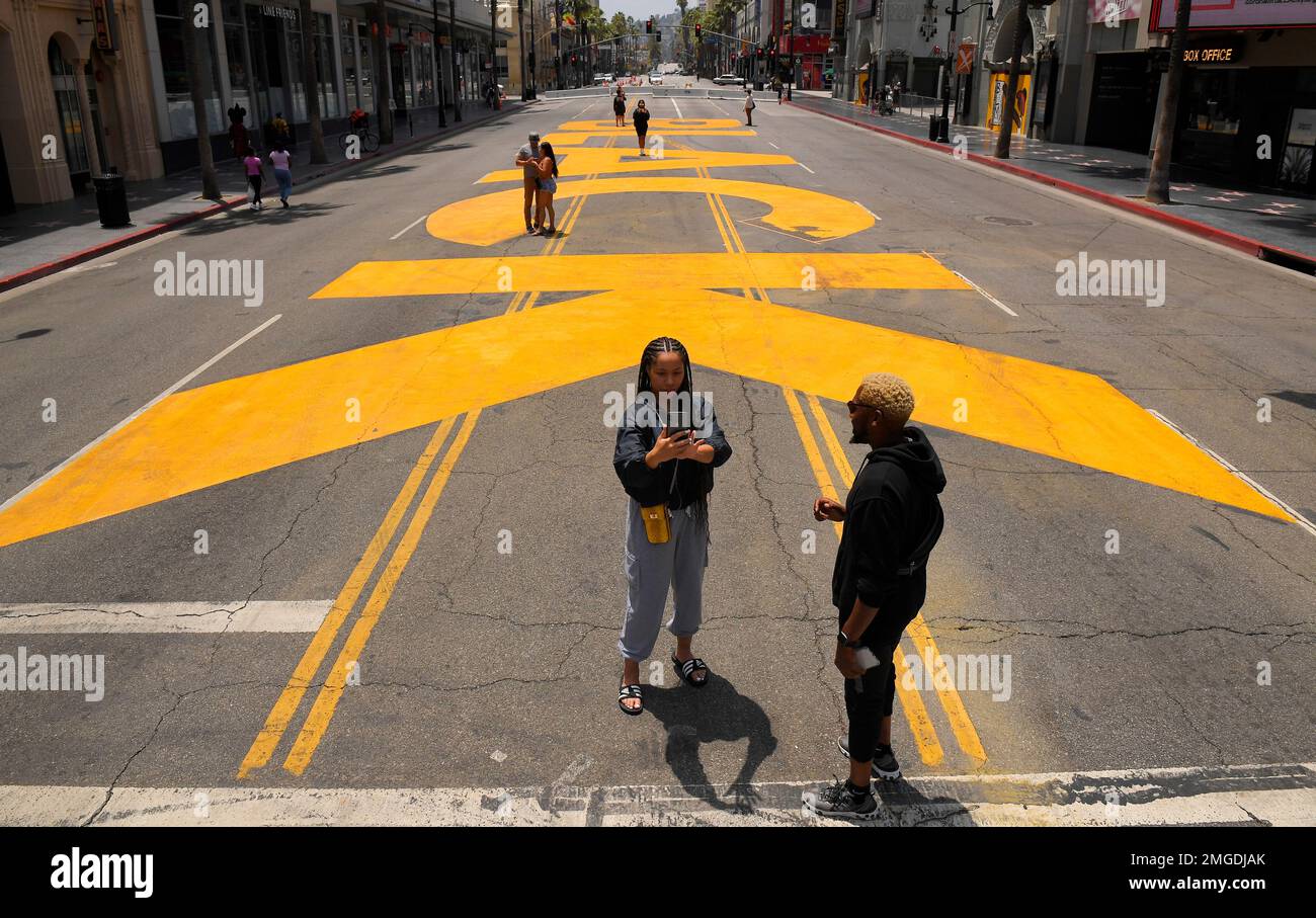 Erin Cox, left, and Paul Styles takes pictures on Hollywood Boulevard ...