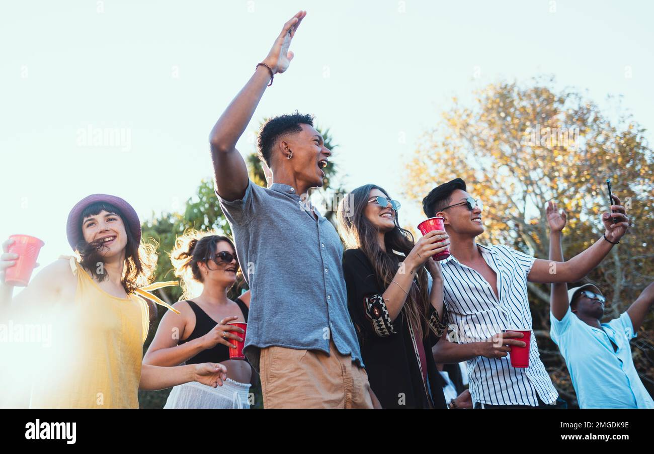 Drinks, party and a crowd of friends outdoor to celebrate at festival ...