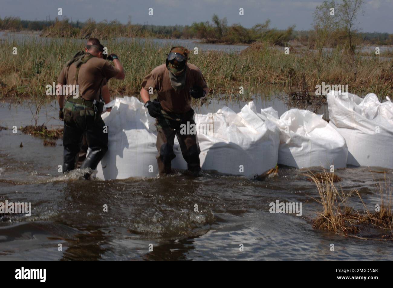 Aircrafts - Sand Baggers - 26-HK-57-106. Military personnel with row of ...