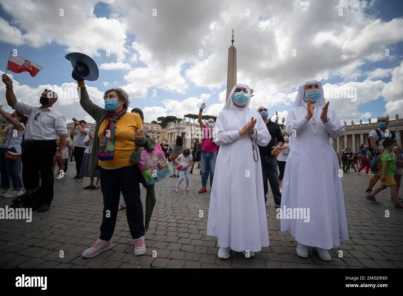Faithful wearing masks to prevent the spread of COVID-19 wave as Pope ...