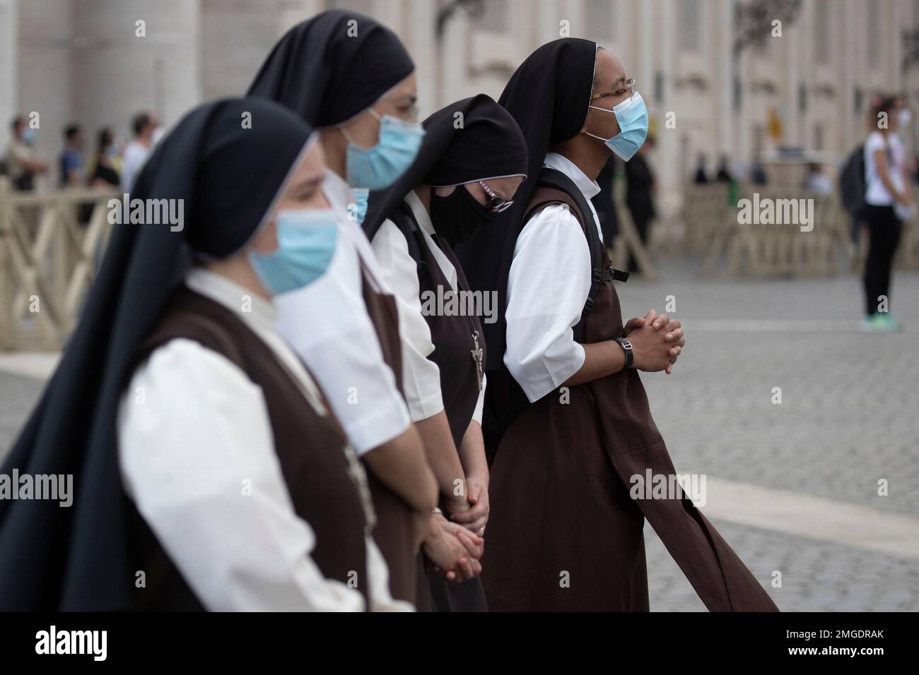Nuns wearing masks to prevent the spread of COVID-19 pray as Pope ...