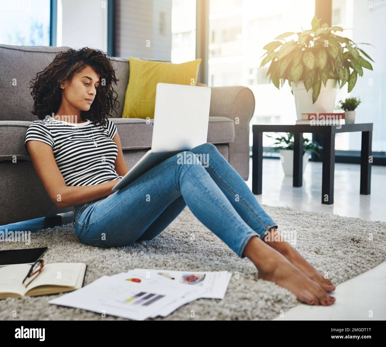 Getting work done at home. a young woman working from home Stock Photo ...