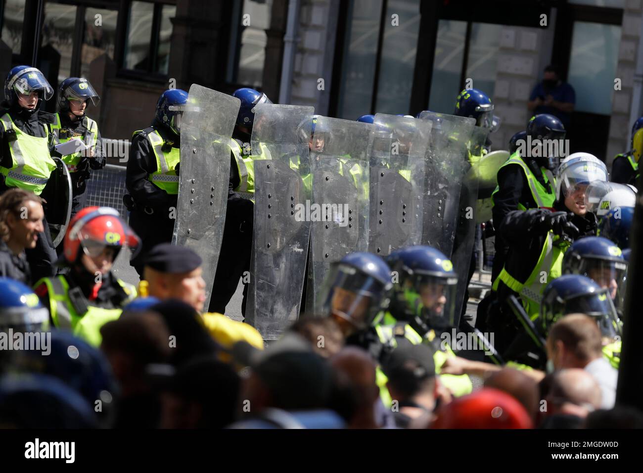 British police officers in riot gear scuffle with members of far-right ...