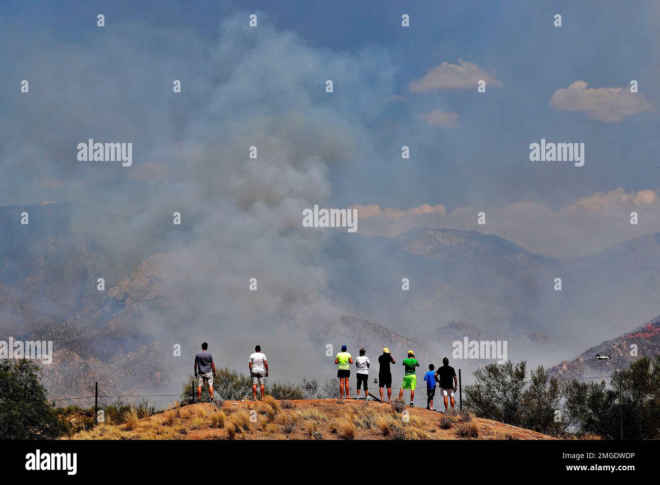 People watch wildfire air attack crews battle the Bighorn Fire along ...