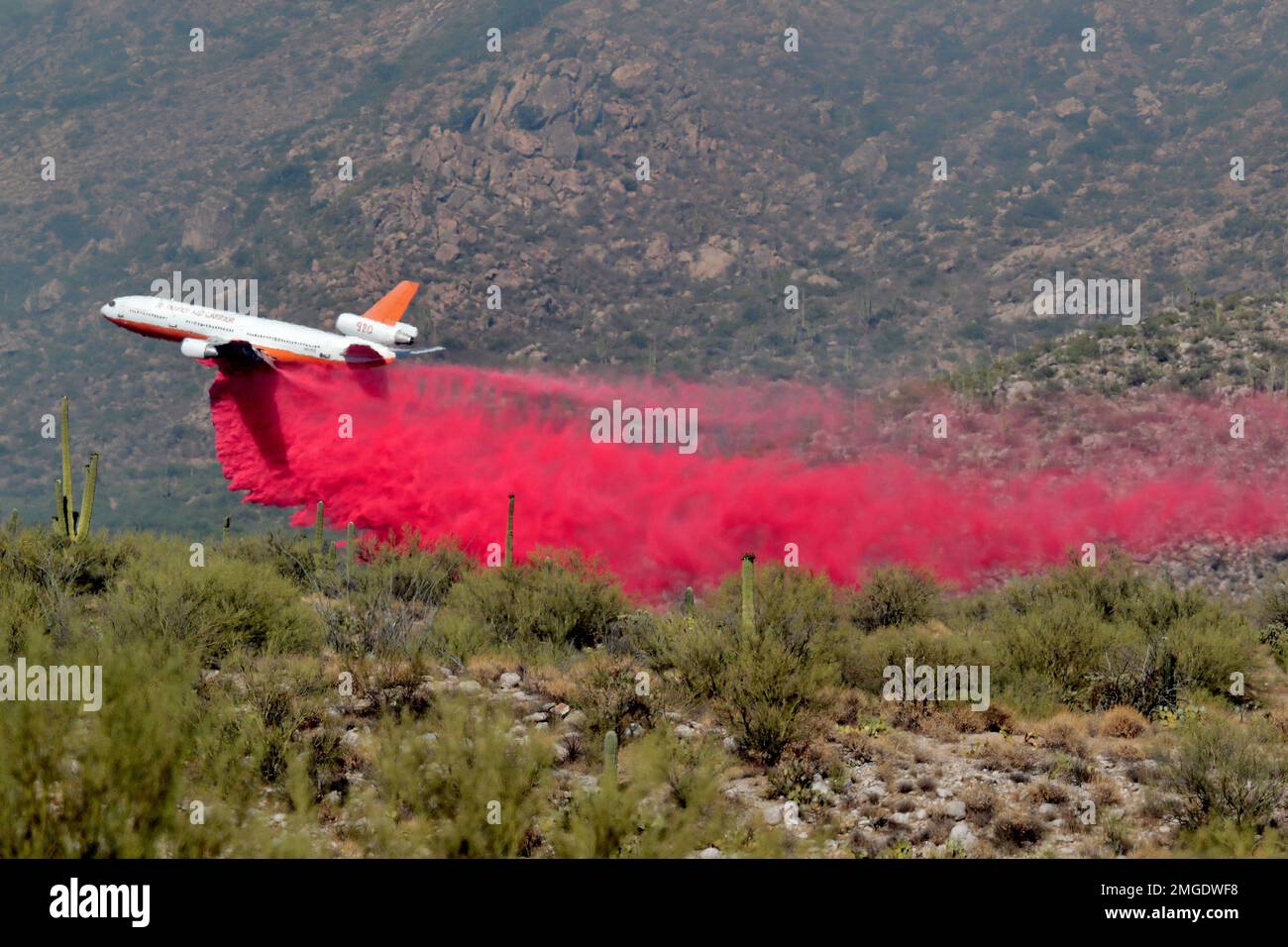 Heat ripples distort an air tanker as it drops retardant on the Bighorn ...