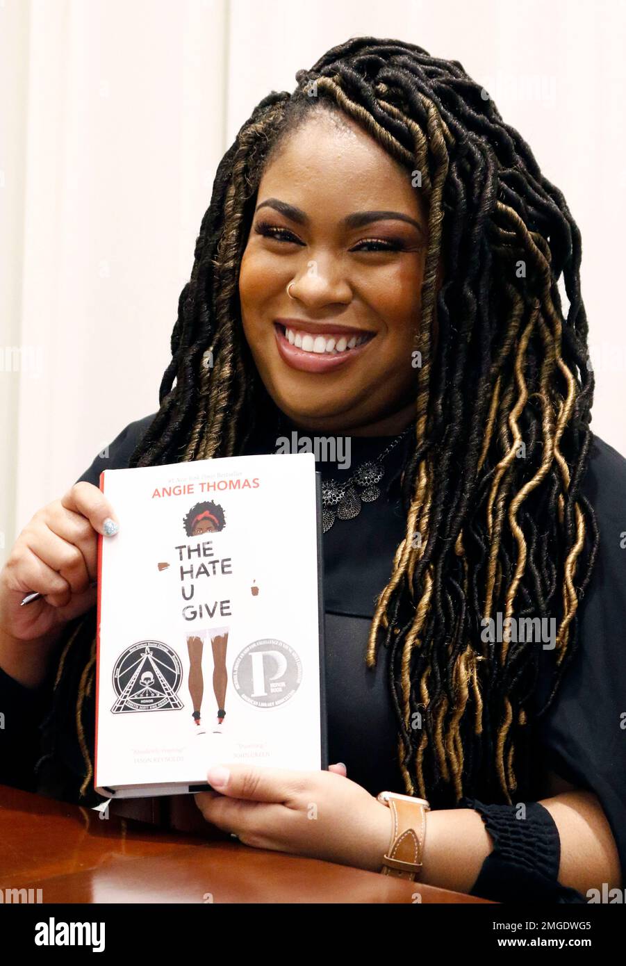 FILE - In this Oct. 10, 2018 photograph, author Angie Thomas holds a ...
