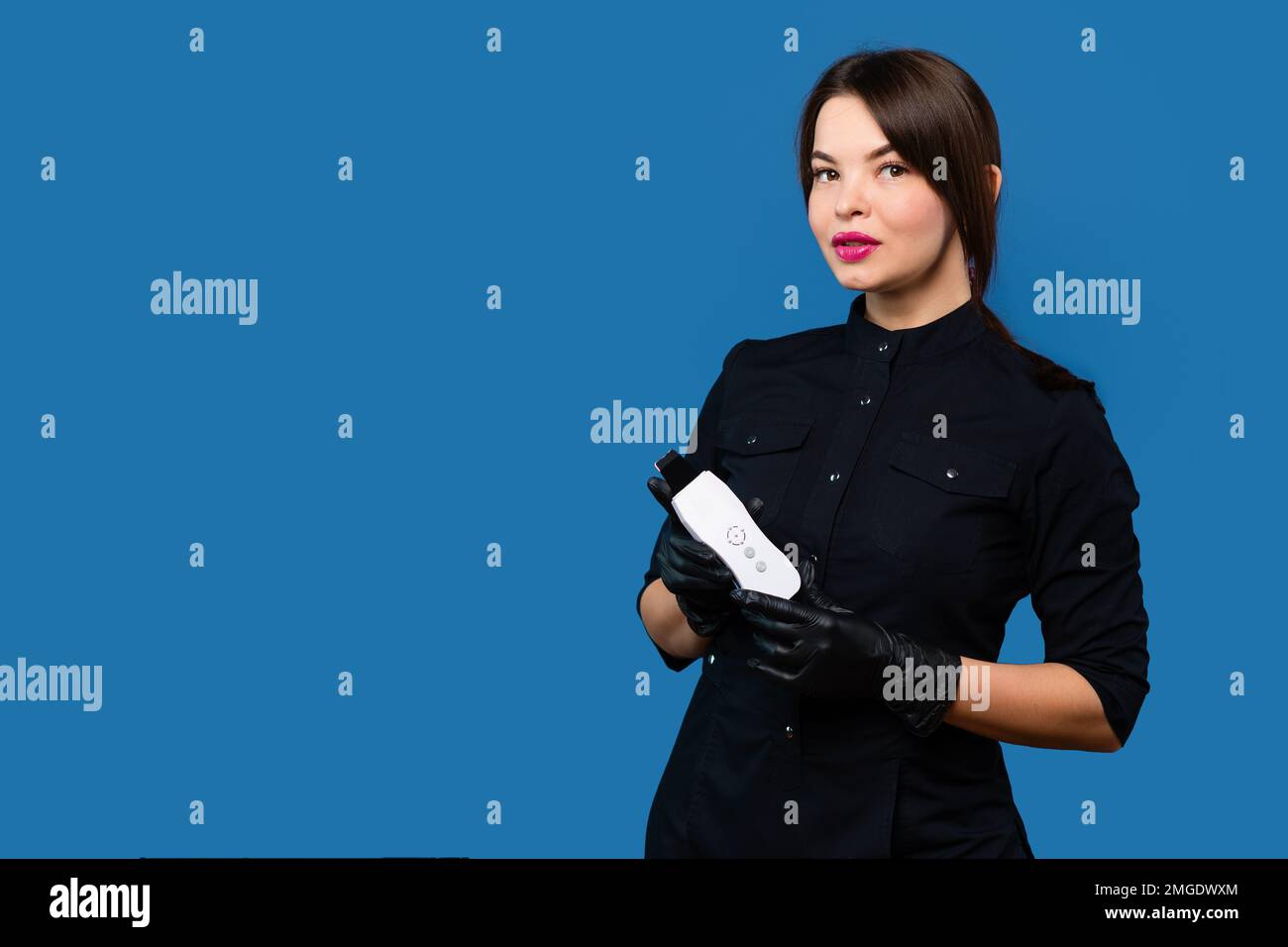 Cosmetician holds handheld ultrasonic facial spatula cleanser. Skincare ...