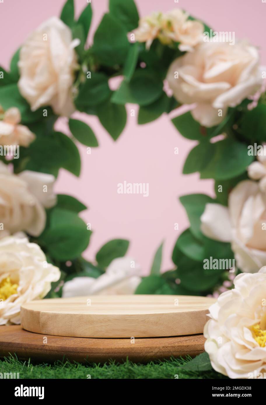 wood podium beige rose flowers on pink pastel background with space ...
