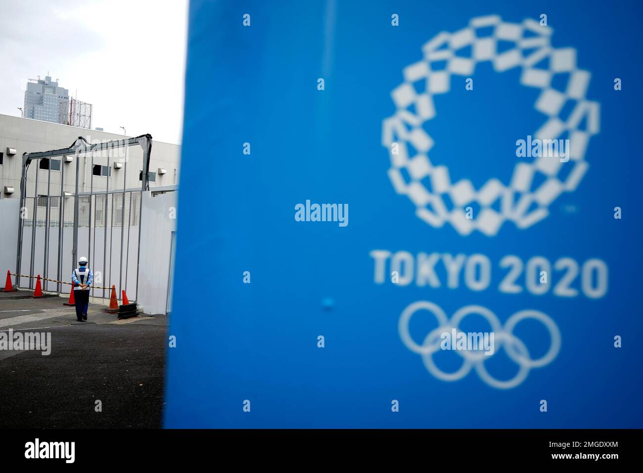 FILE.- In this May 12, 2020, file photo, a lone security guard stands ...