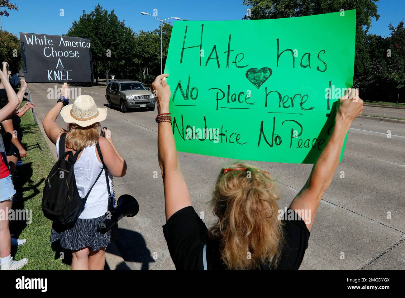 Protesters gather at a busy intersection in the Preston Hollow ...