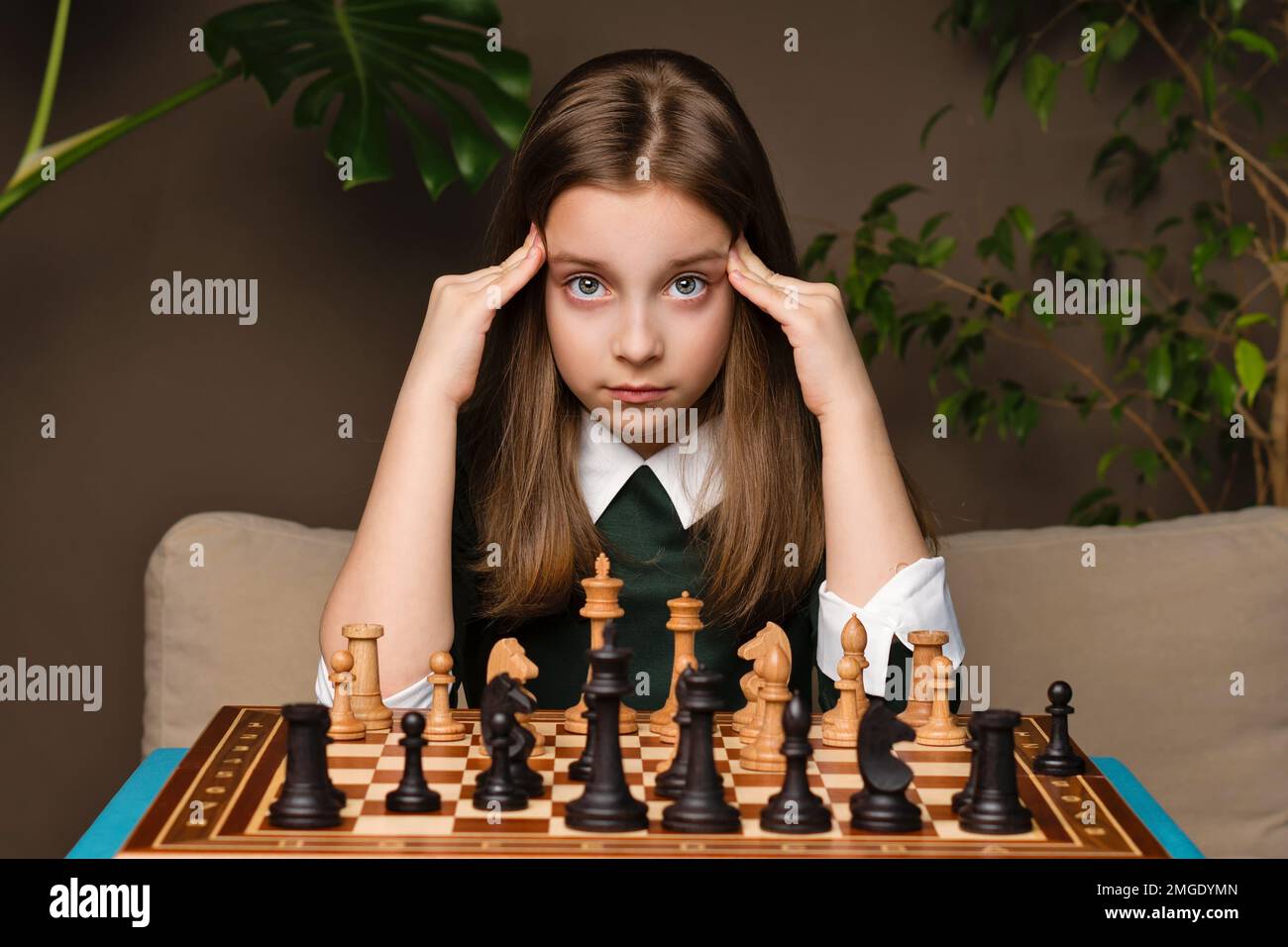 Portrait thoughtful schoolgirl chess player. Serious female teen ...