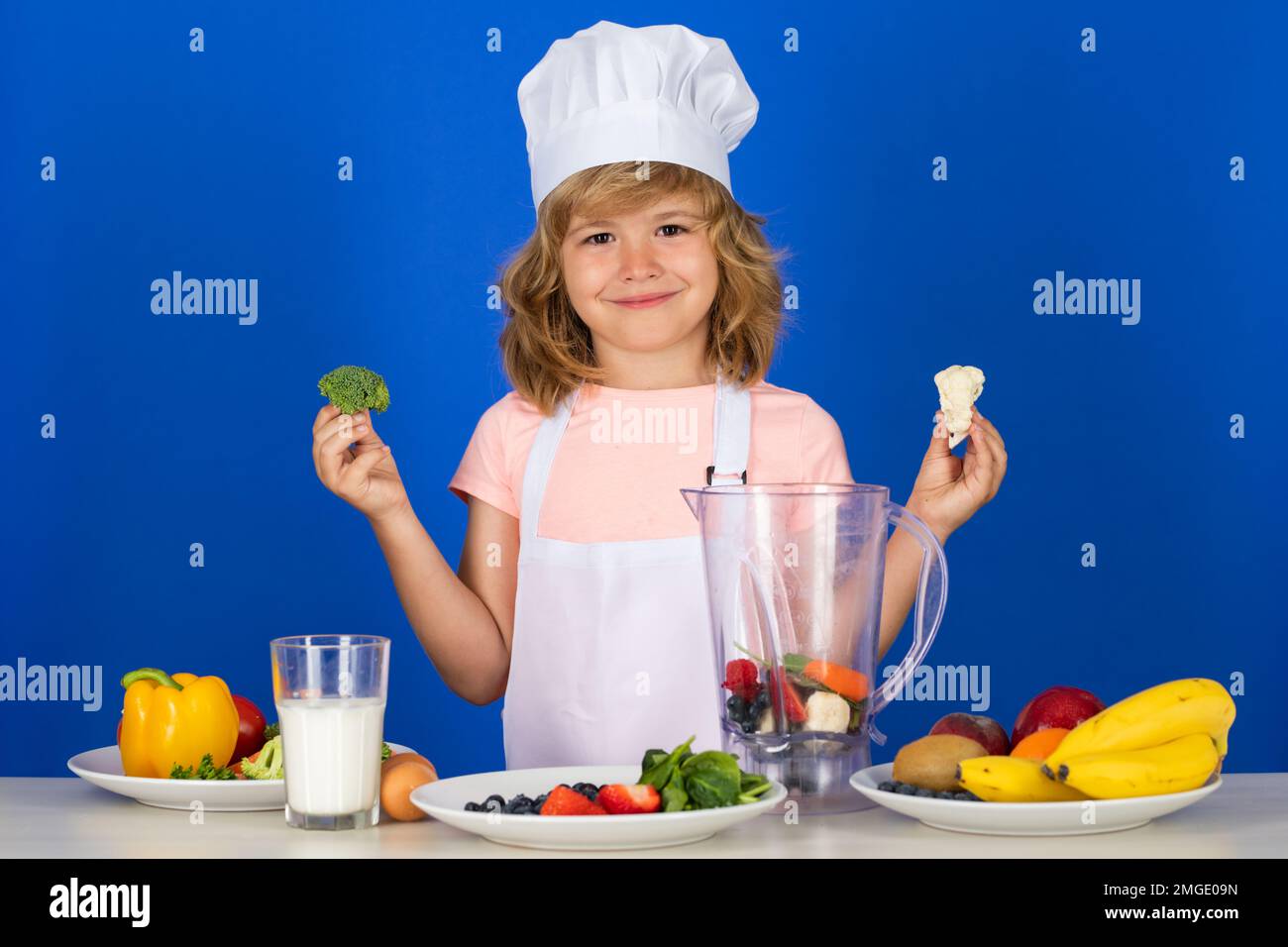 Cooking children. Chef kid boy hold broccoli making fresh vegetables ...