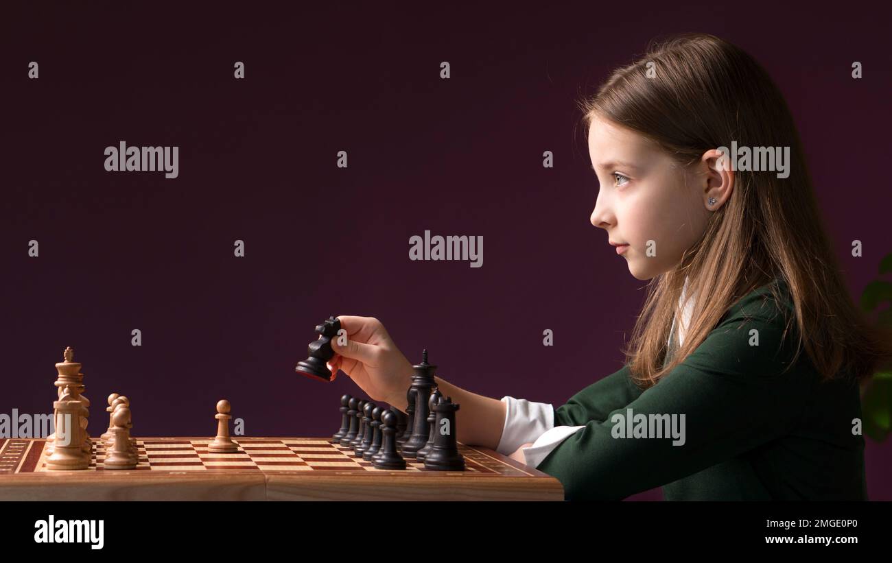 Teen girl playing chess. Young chess player at chessboard during game ...