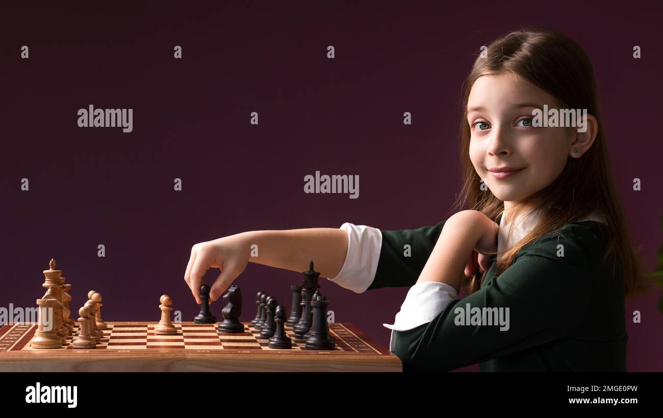 Teen girl playing chess. Young chess player posing sitting at ...
