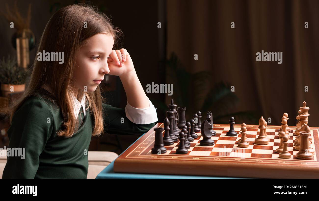 Thoughtful teenager girl playing logical board game. Young chess player ...
