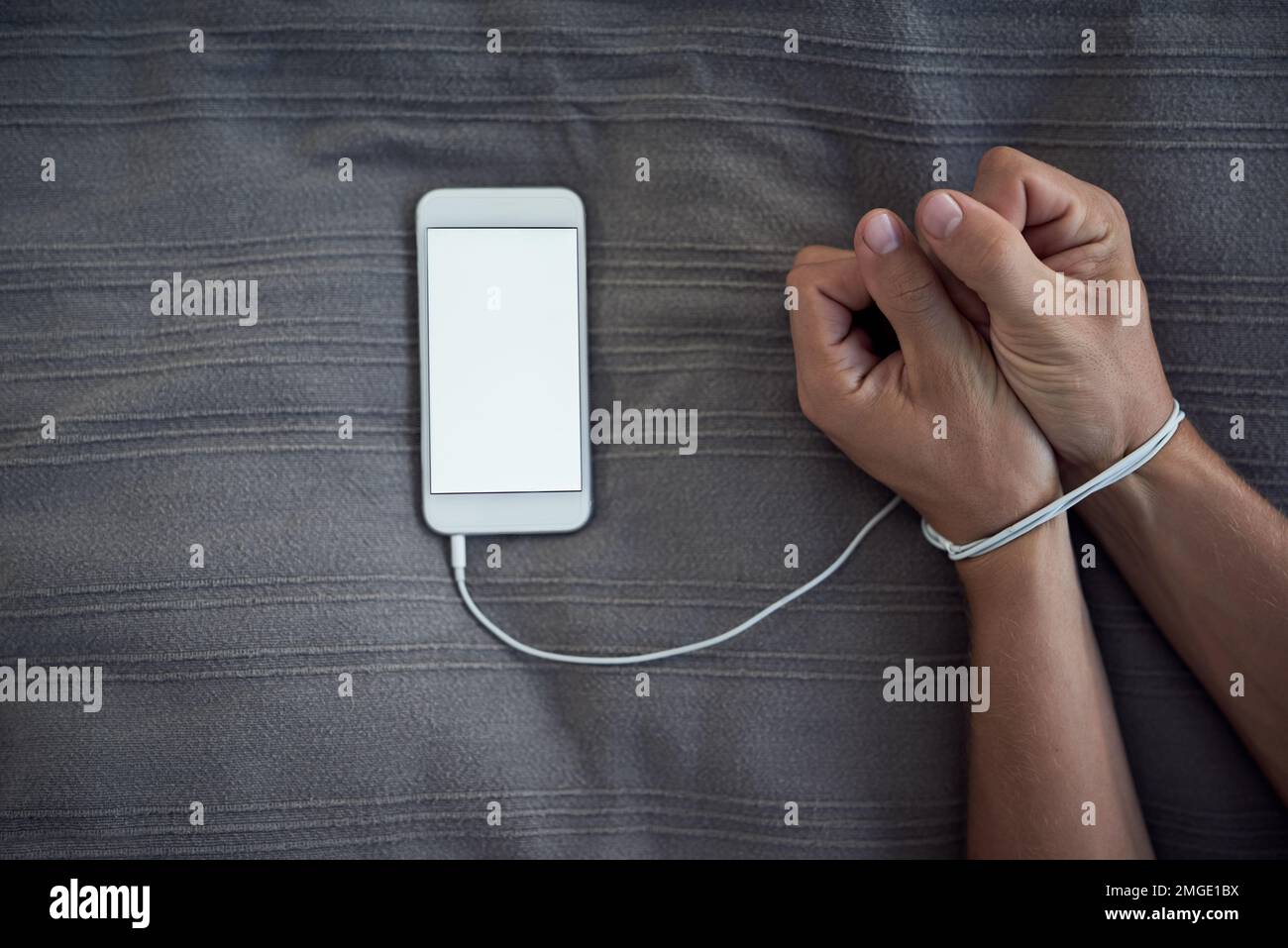 We are all prisoners of tehcnology. a unrecognizable persons hands ...